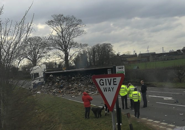 Trailer load of scrap metal strewn across the busy stretch of A420 in ...