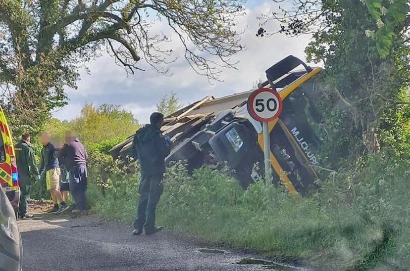 Road closed after M J Church lorry overturns in roadside ditch