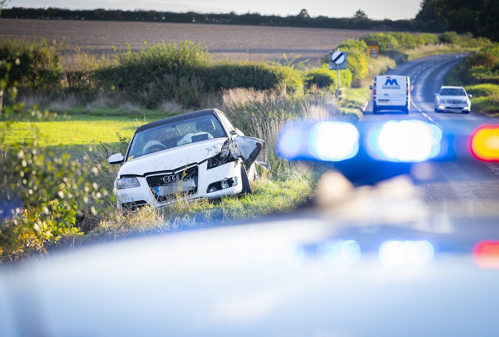 A-road partially blocked after car leaves carriageway and crashes into tree