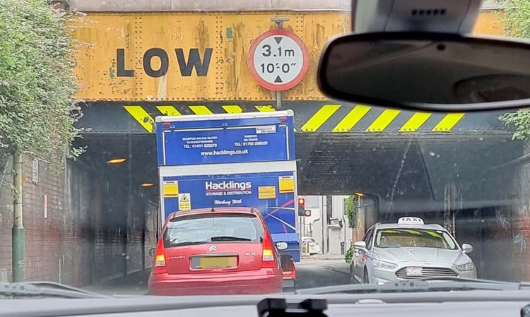 Traffic delays as lorry gets wedged under low bridge in Swindon