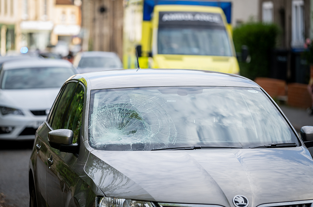 Car windscreen suffers 'bullseye' as cyclist suffers medical episode