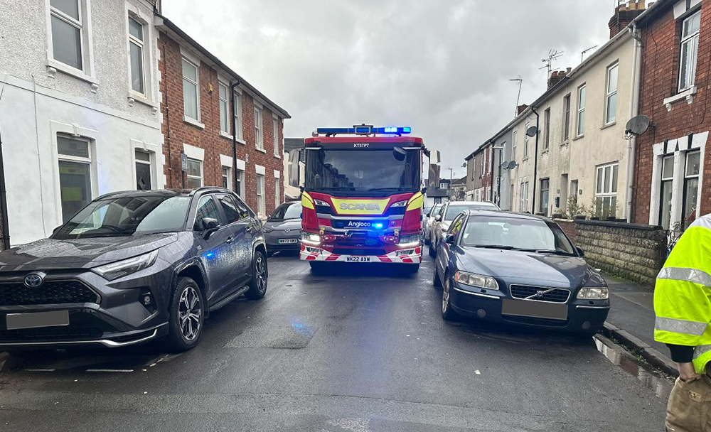 Fire engine responding to emergency call blocked by parked cars