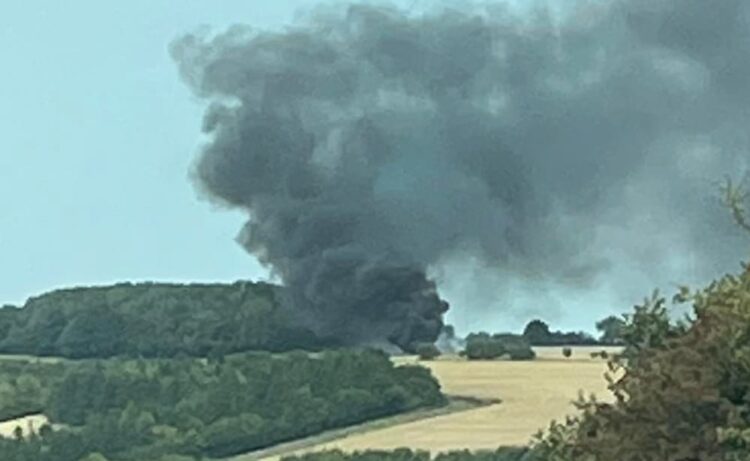 Combine harvester bursts into flames creating huge smoke plume